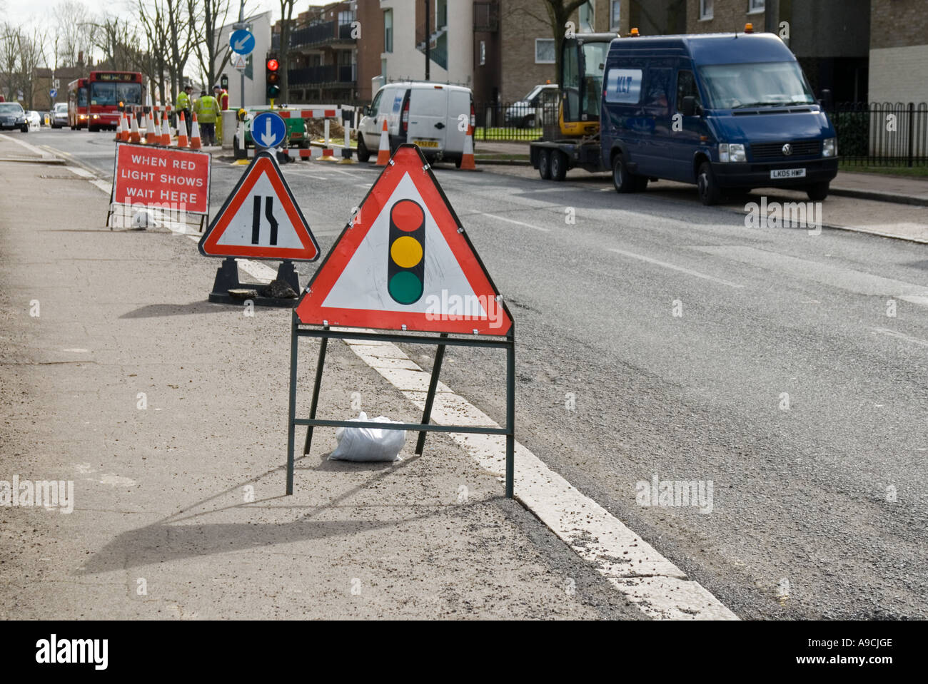 Wait here when red light shows road sign Stock Photo - Alamy