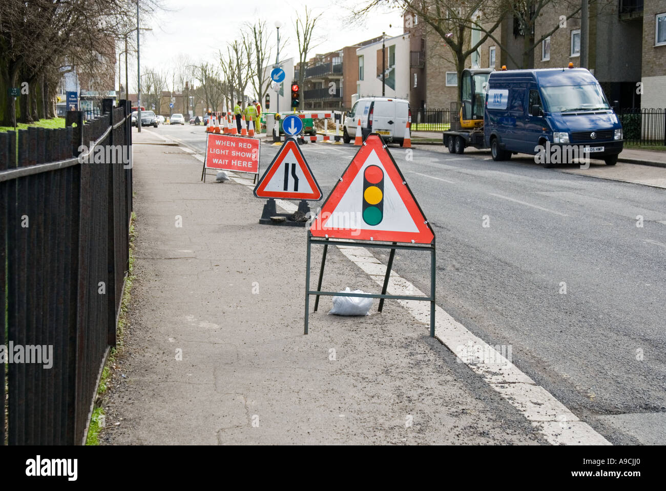 When red light shows wait here road sign Stock Photo - Alamy