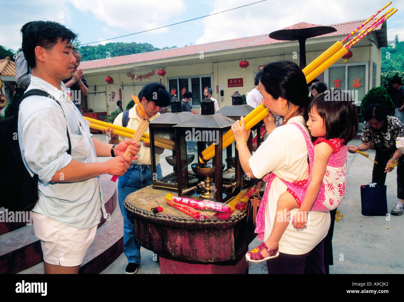 Worshipper lighting up big incense for offering in the buddha birthday ...
