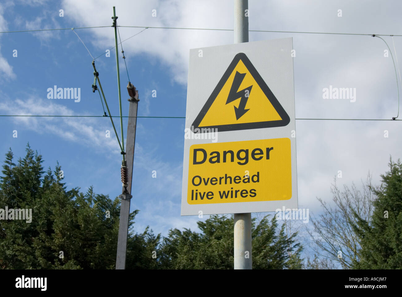 Sign indicating overhead live wires Stock Photo - Alamy
