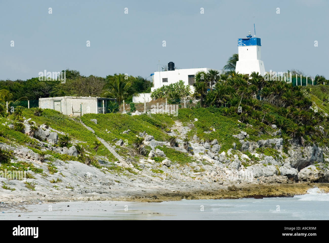 Tulum lighthouse on a rock Mexico Stock Photo - Alamy