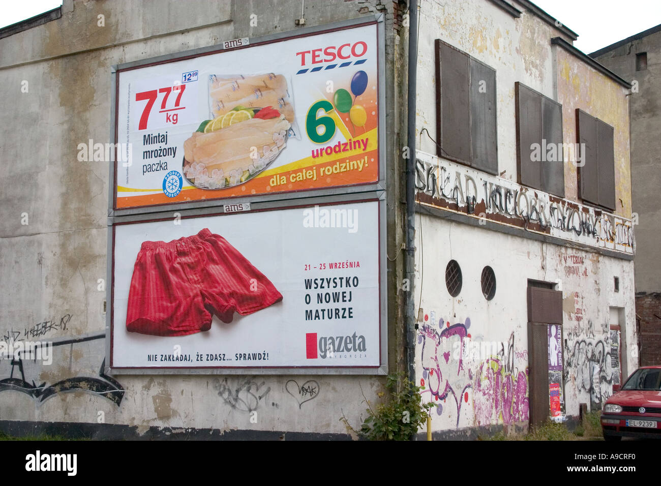 Billboards on side of graffiti covered building near the Balucki Rynek ...