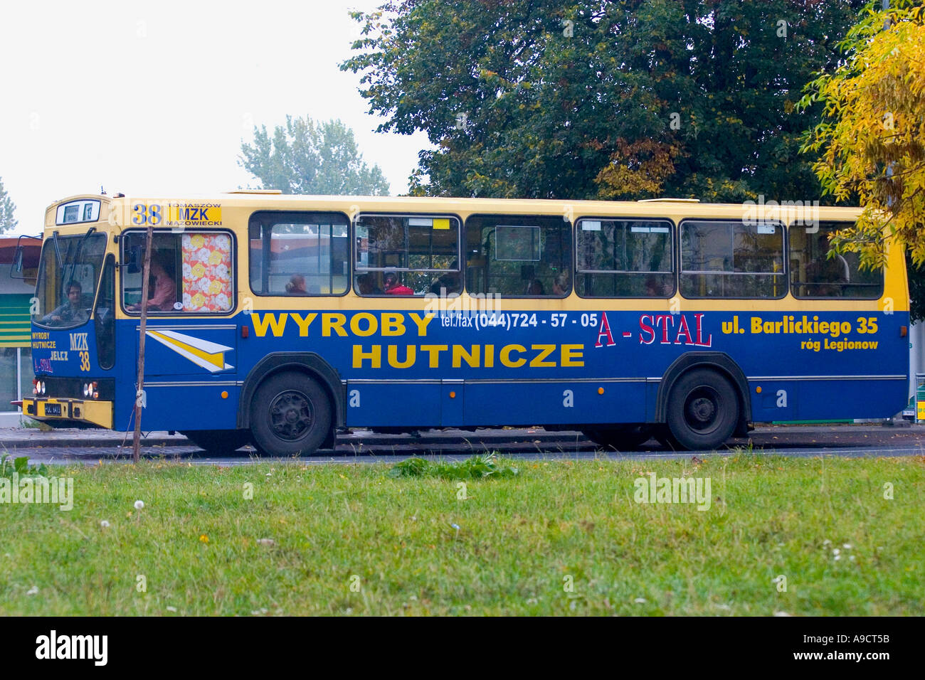 Yellow and blue Polish bus picking up passengers. Highway 72 between ...
