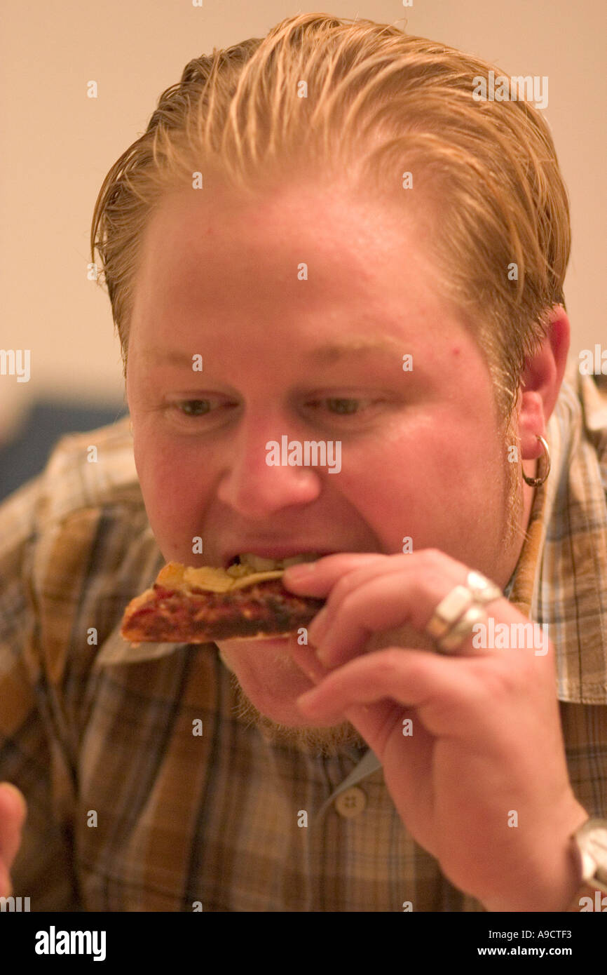 Young man taking big bite hi-res stock photography and images - Alamy