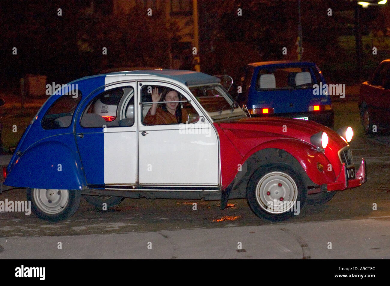Citroen 2CV or French Deux Chevaux auto red white and blue with woman ...