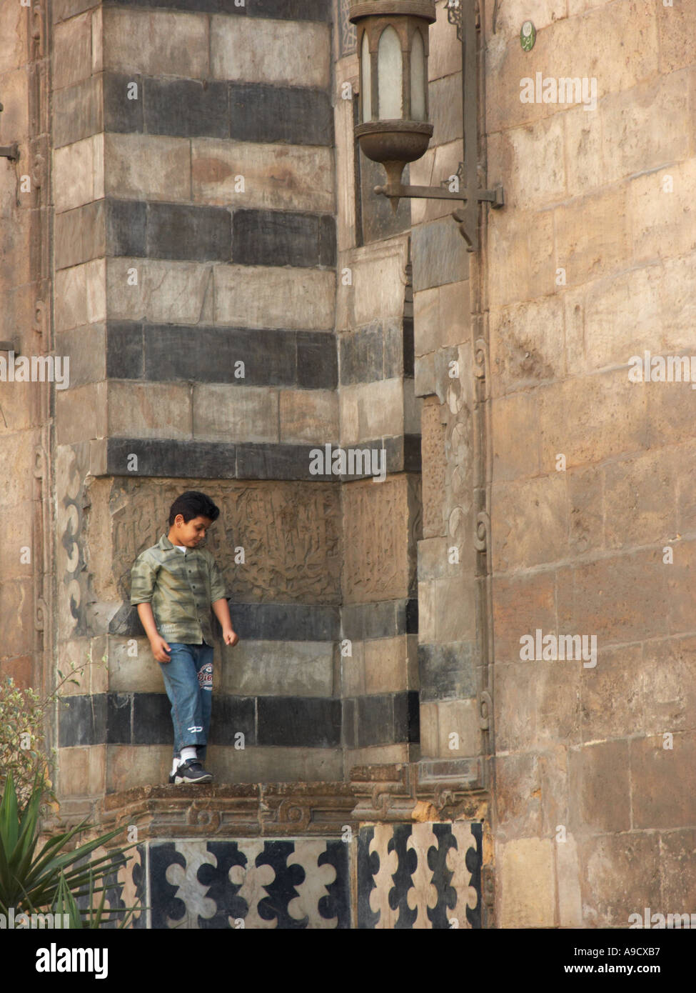 Egyptian boy in archway of mosque in Cairo Egypt Stock Photo - Alamy