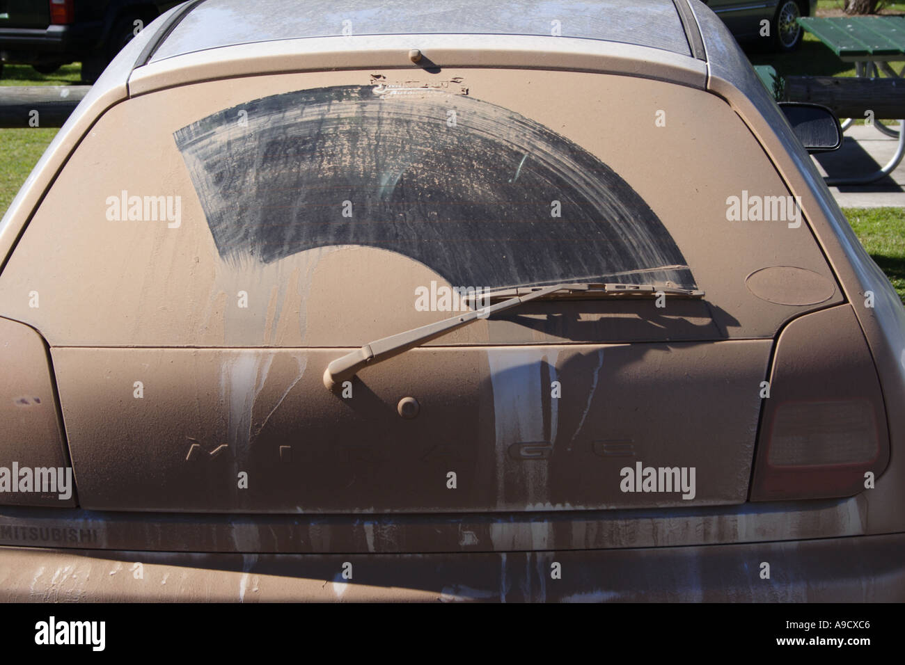 A HEAVY LAYER OF DUST ON THE BACK WINDSCREEN OF A CAR OUTBACK AUSTRALIA ...