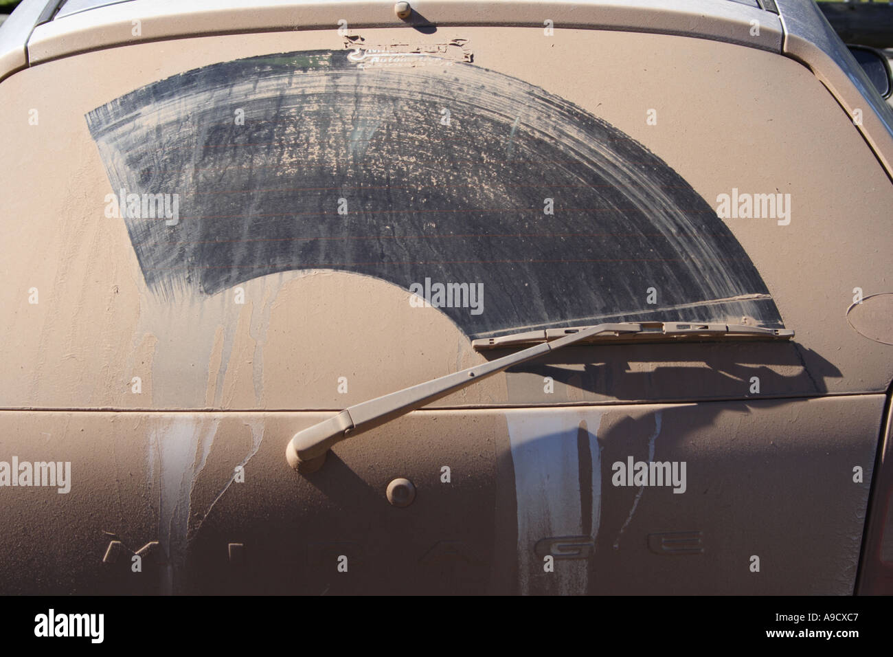 A HEAVY LAYER OF DUST ON THE BACK WINDSCREEN OF A CAR OUTBACK AUSTRALIA ...