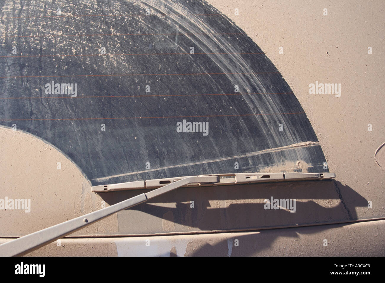 A HEAVY LAYER OF DUST ON THE BACK WINDSCREEN OF A CAR OUTBACK AUSTRALIA ...