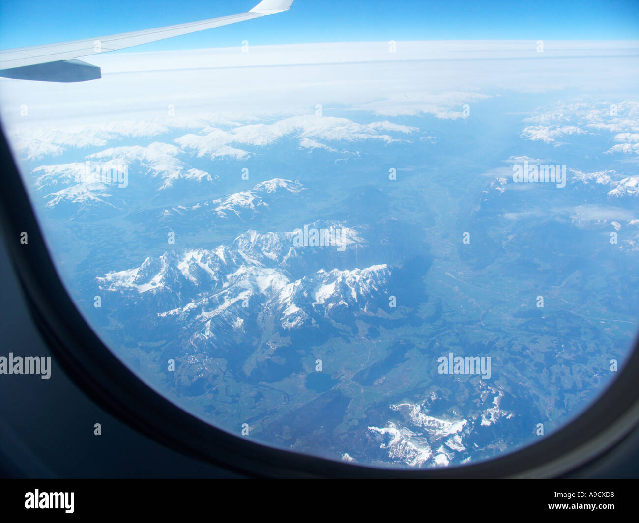 view from passenger aircraft window flying over mountains Stock Photo ...