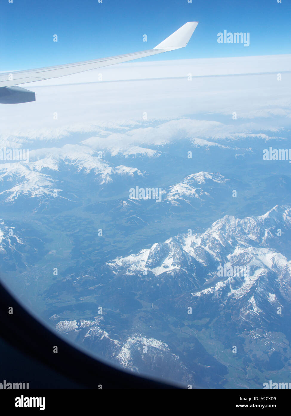view from passenger aircraft window flying over mountains Stock Photo ...