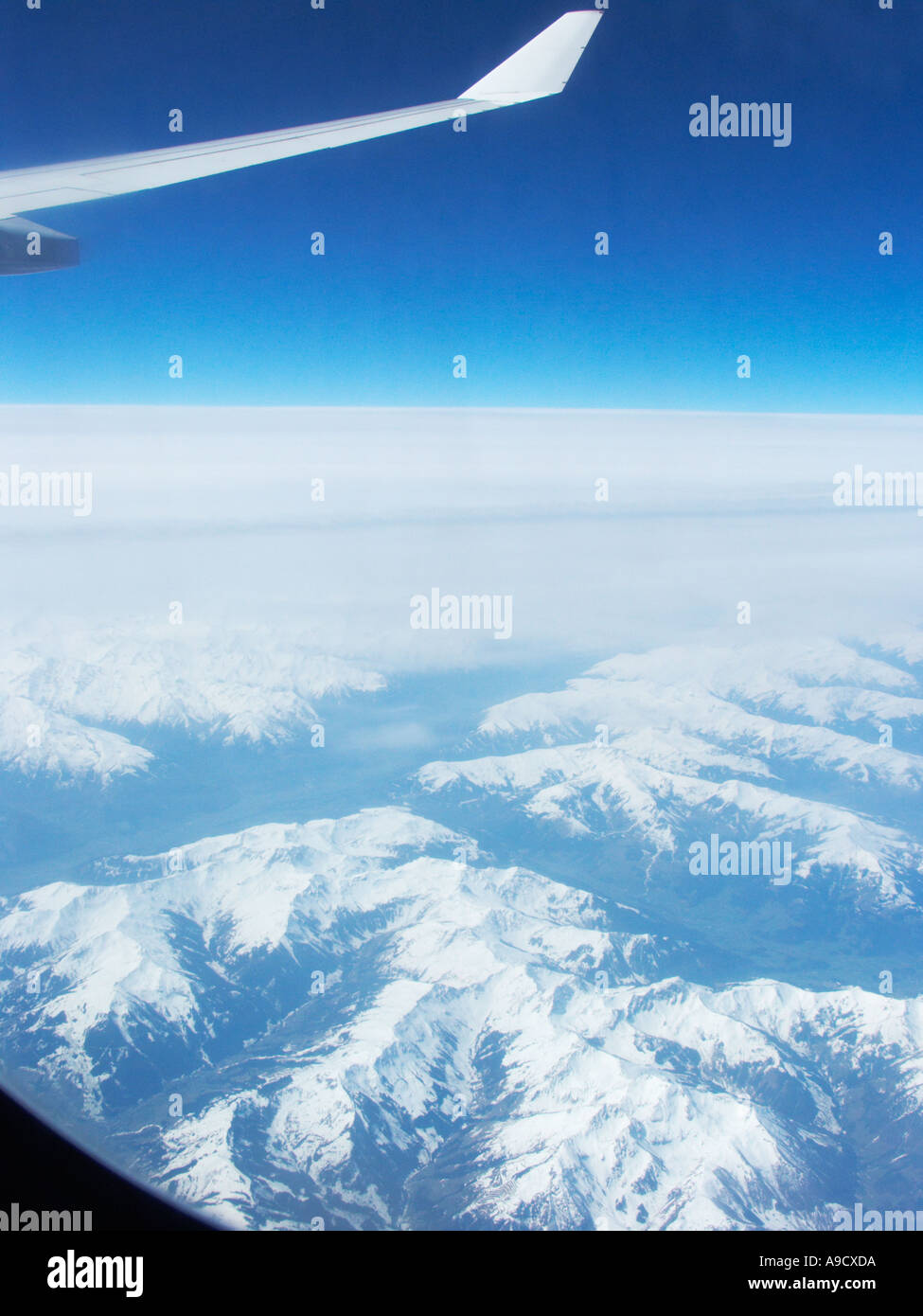 view from passenger aircraft window flying over mountains Stock Photo ...