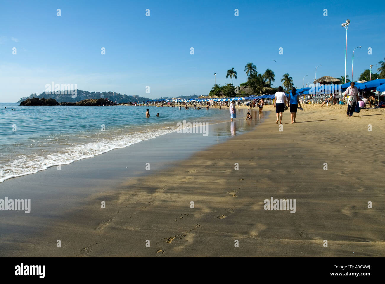 Acapulco women walk long the boot topping - Mexico Stock Photo - Alamy