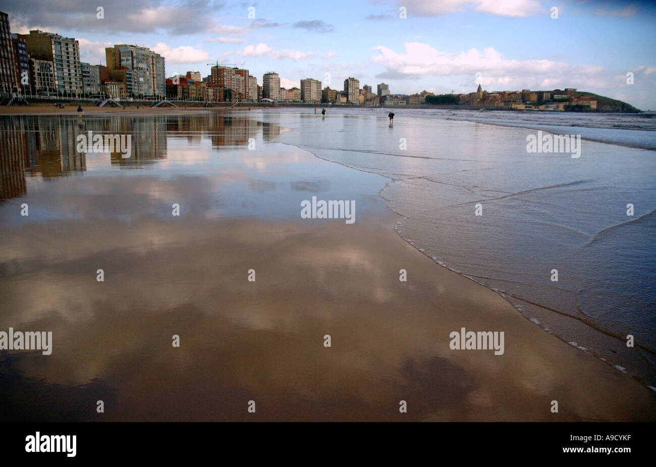 Low tide reflection. View of the seafront and beach of Gijon Xixon ...