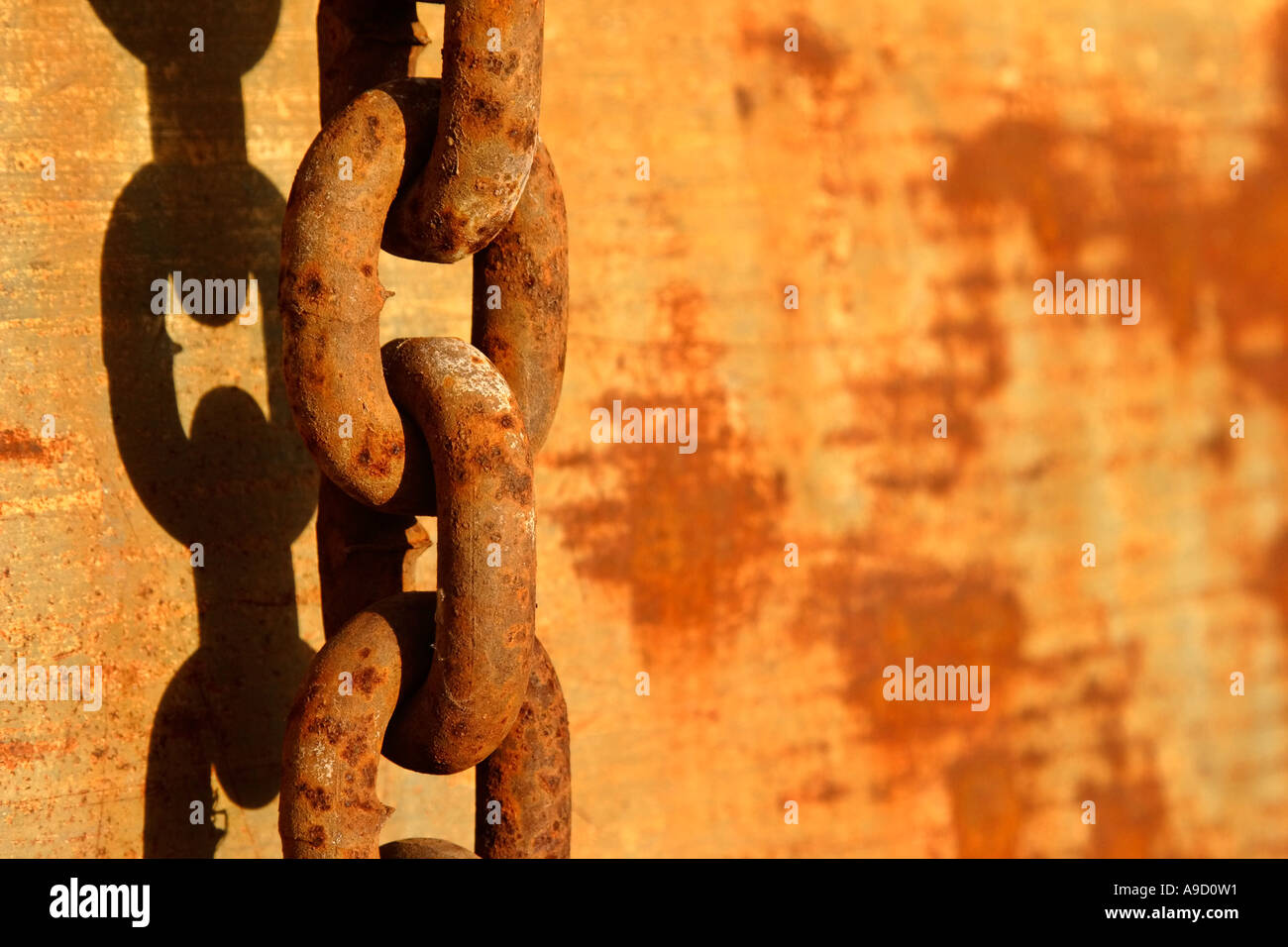 rusting chain beside rusting heavy metal Stock Photo - Alamy