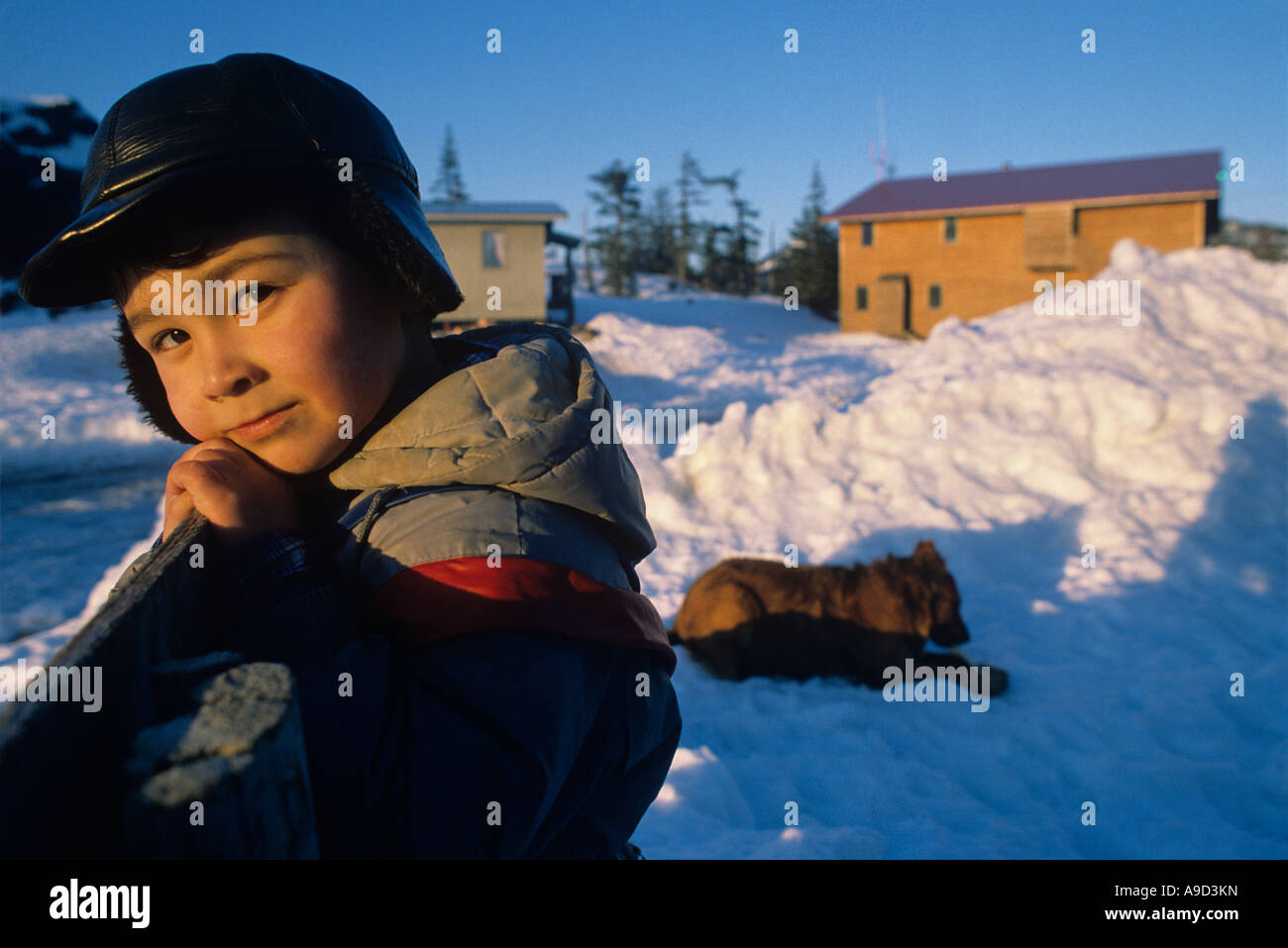 USA Alaska Young Eskimo boy plays with basketball in snow in Prince ...