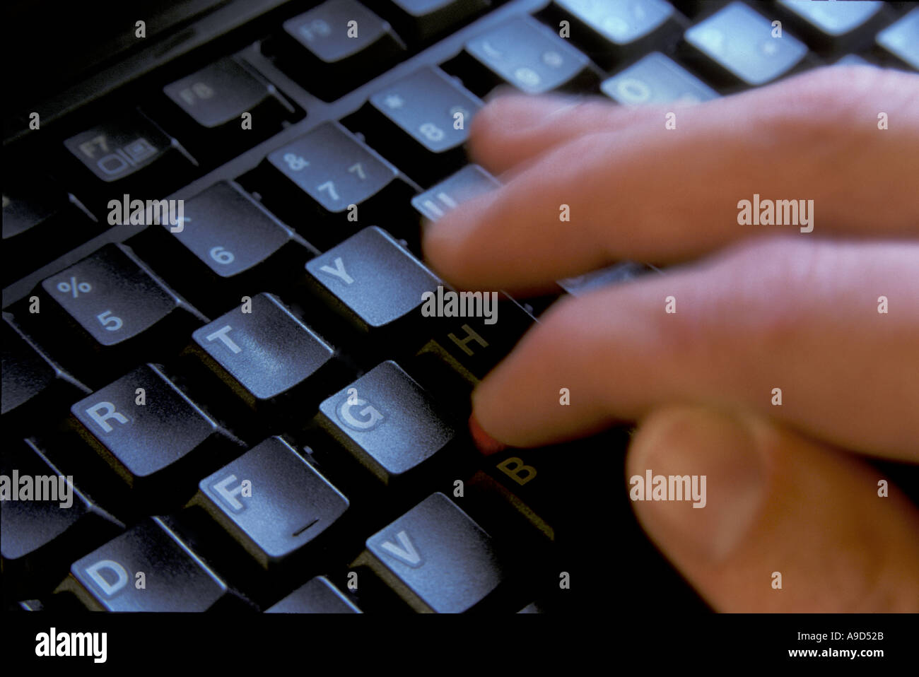 Laptop keyboard and hand Stock Photo - Alamy