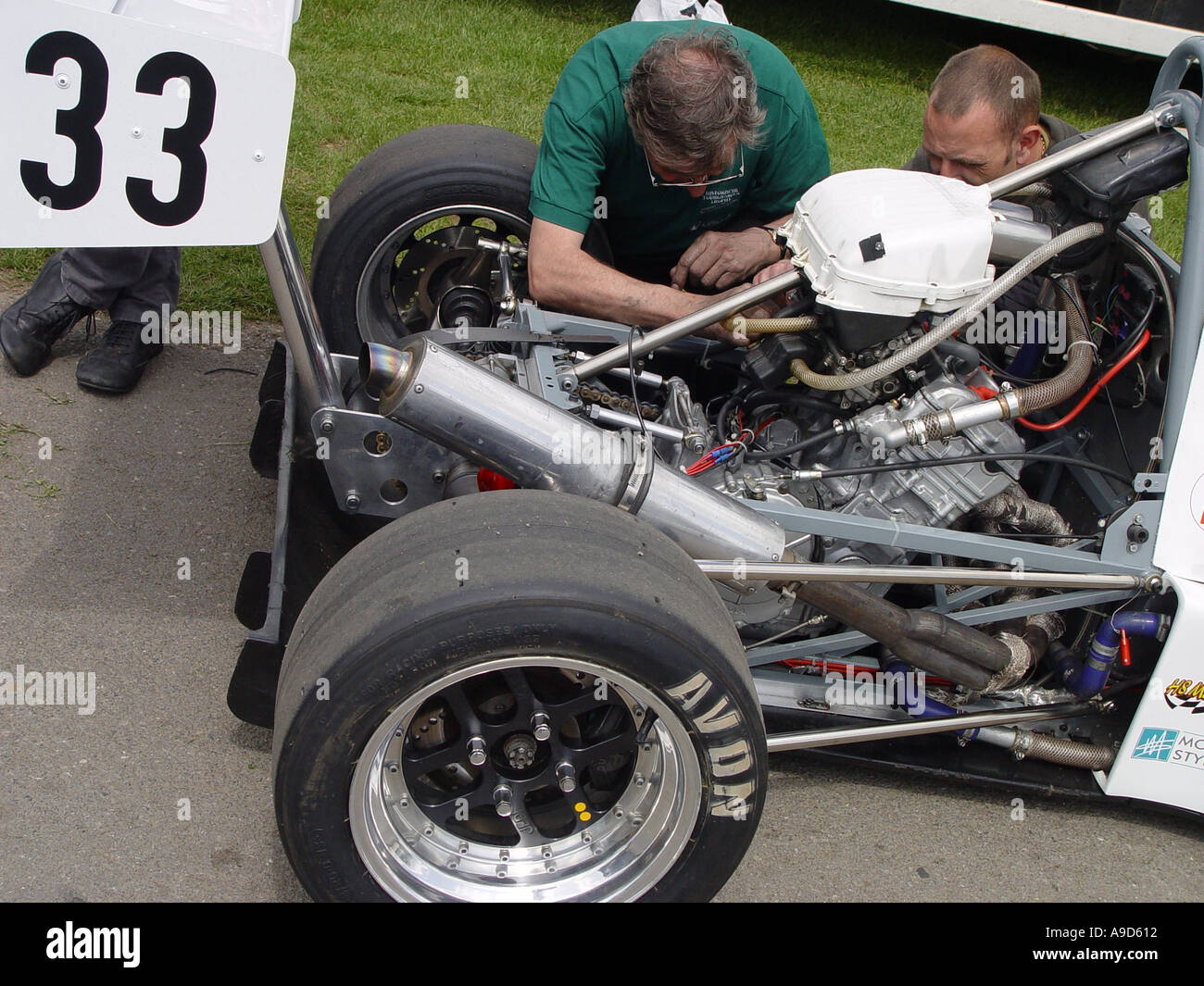 Mechanics working on a motor racing car at a motorsport event in ...