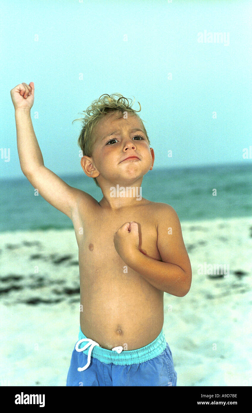 boy holds up his right hand at the beach Stock Photo - Alamy