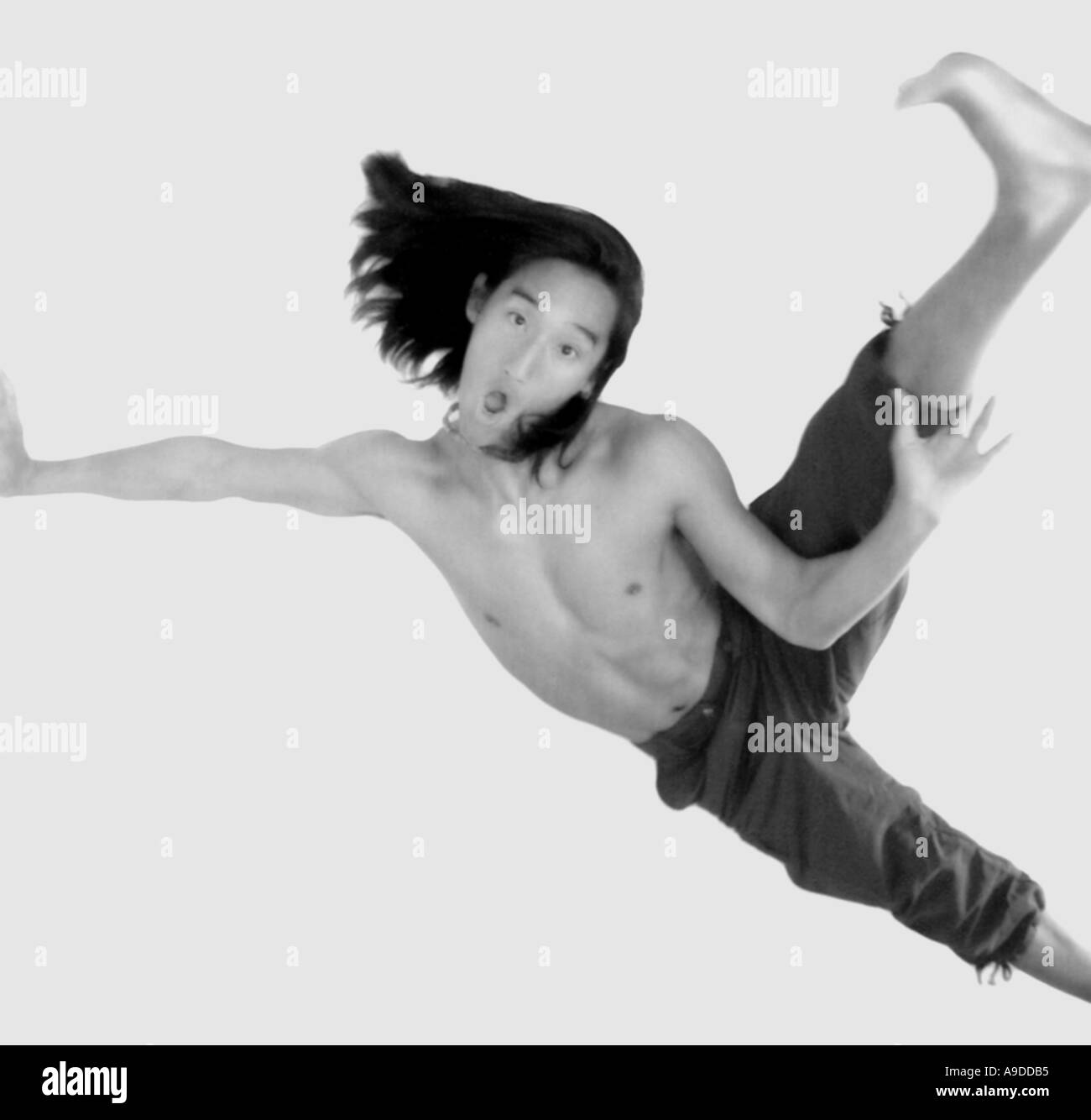 young man performing gymnastic feat during dance routine Stock Photo ...