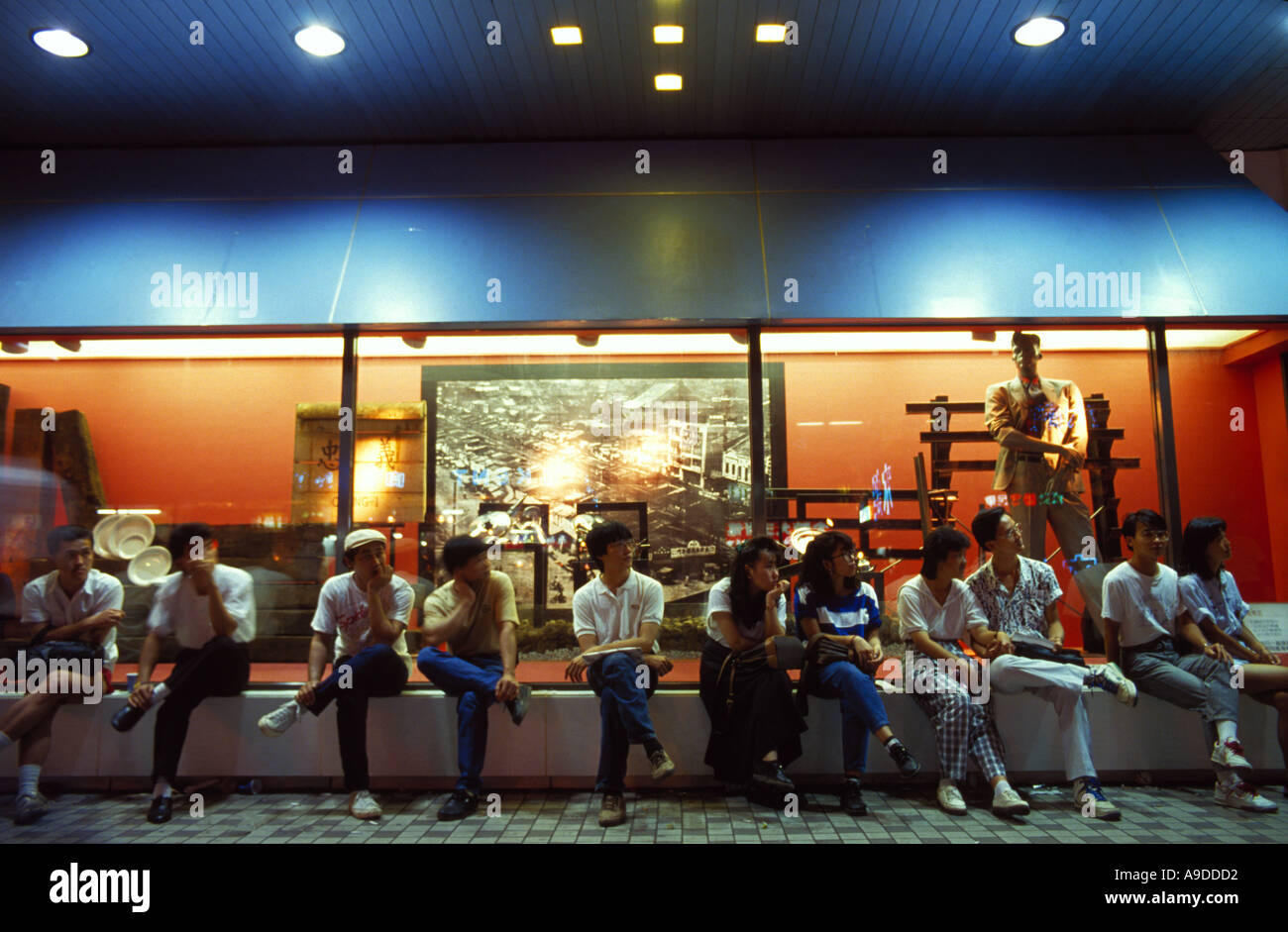 People waiting in front of a department store window display Taipei ...