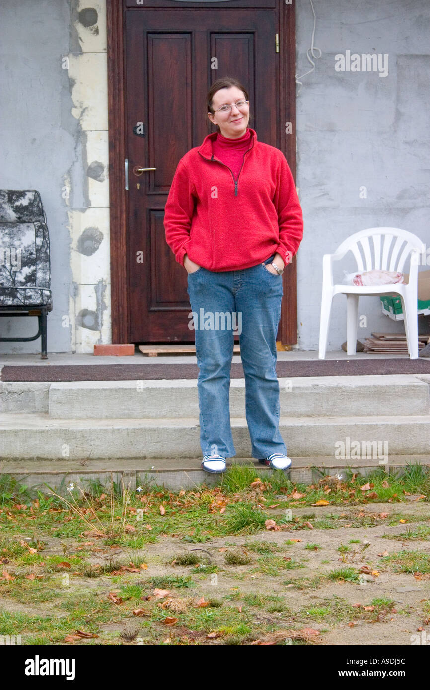 Happy Polish woman smiling and standing in front of her unfinished ...