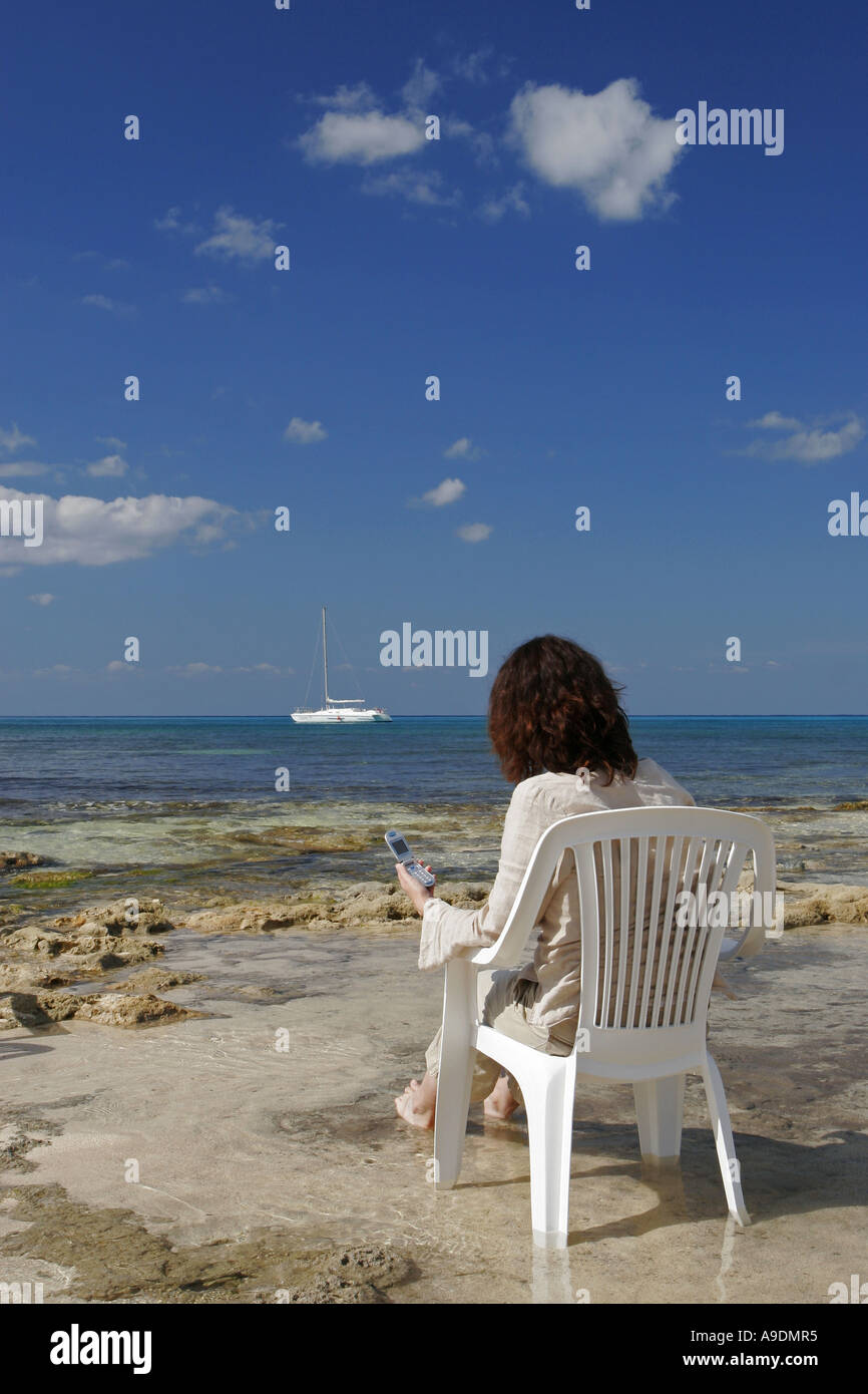 Woman using mobile phone on beach cozumel hi-res stock photography and ...