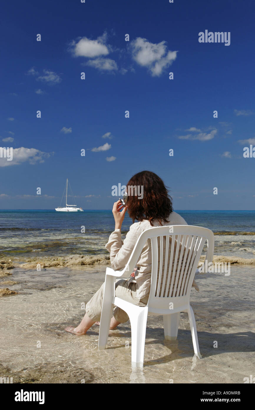Woman using mobile phone on beach cozumel hi-res stock photography and ...