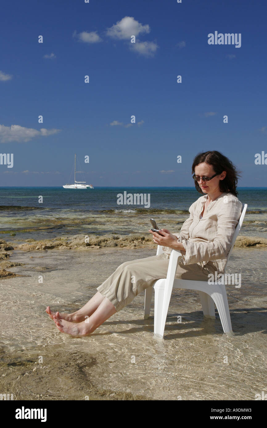 Woman using mobile phone on beach cozumel hi-res stock photography and ...