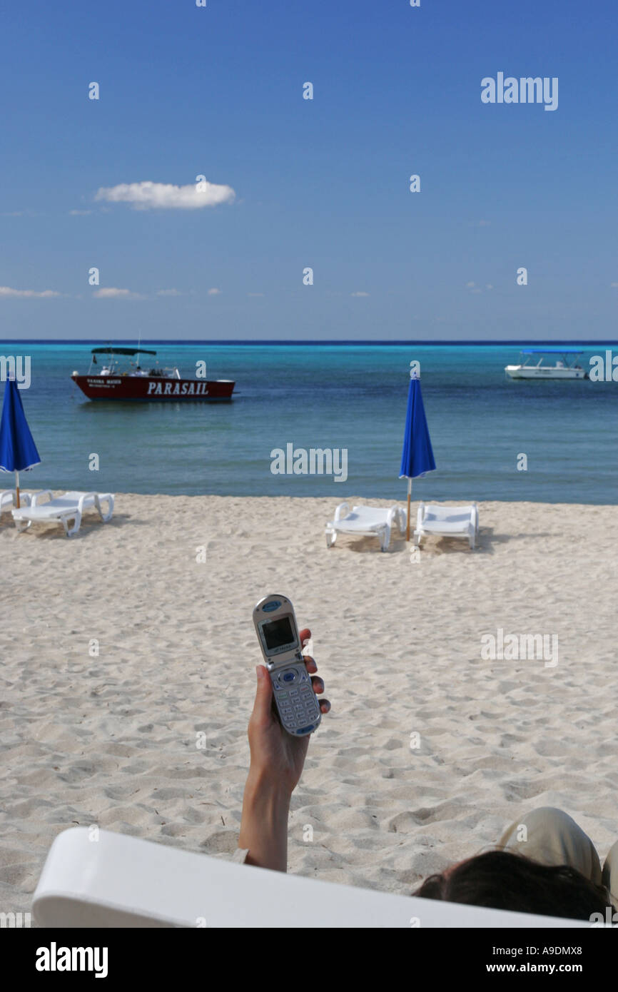 Woman using mobile phone on beach cozumel hi-res stock photography and ...