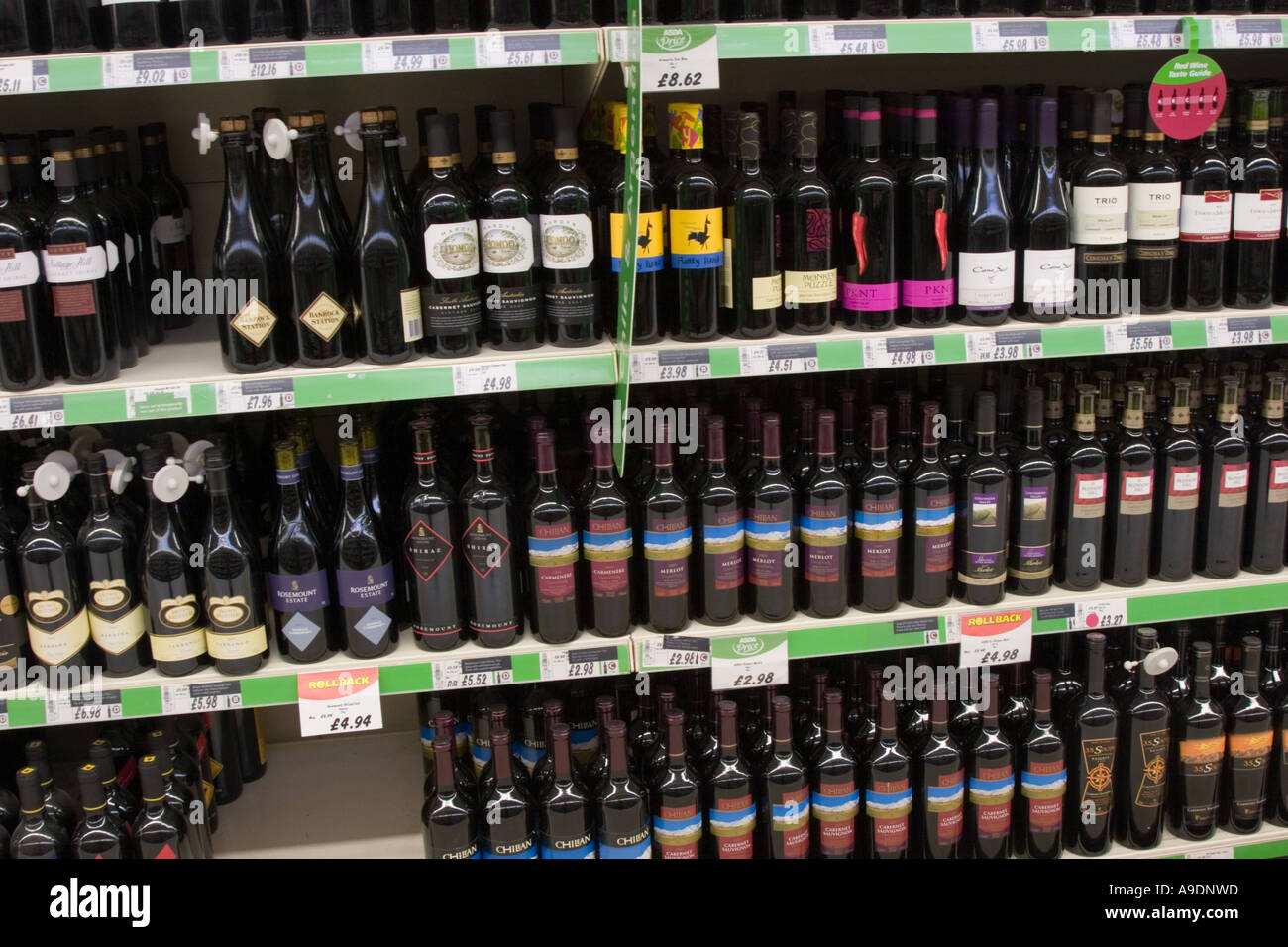 Bottles of wine line up on a supermarket shelf Stock Photo - Alamy