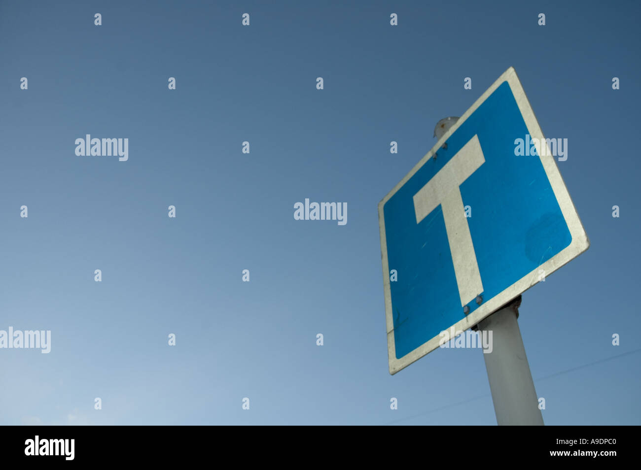 T junction sign with blue sky background in London England Stock Photo ...
