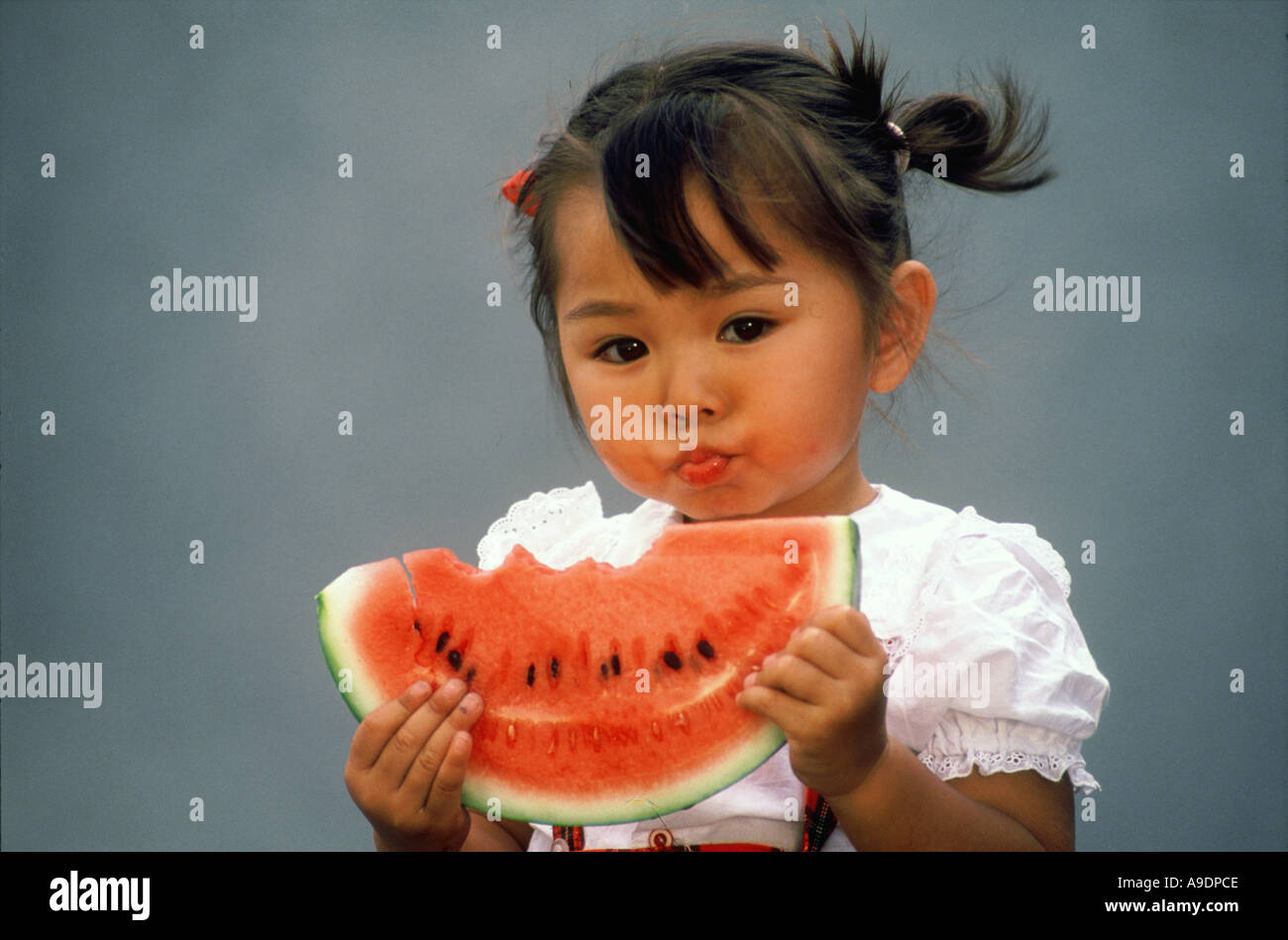 Japanese girl eating watermelon Stock Photo - Alamy
