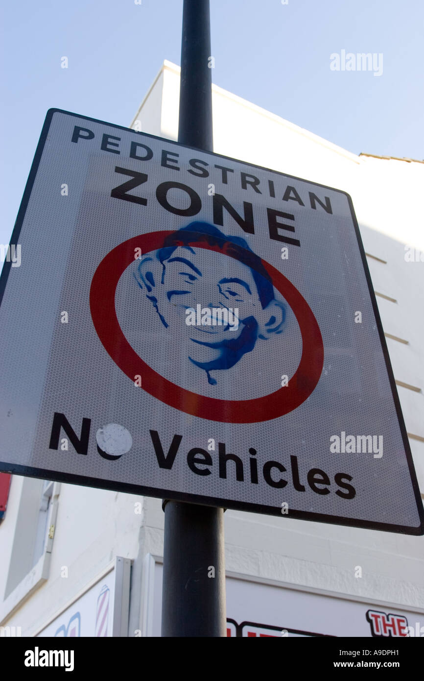 Pedestrian zone sign with graffiti stencil face of Prime Minister Tony ...