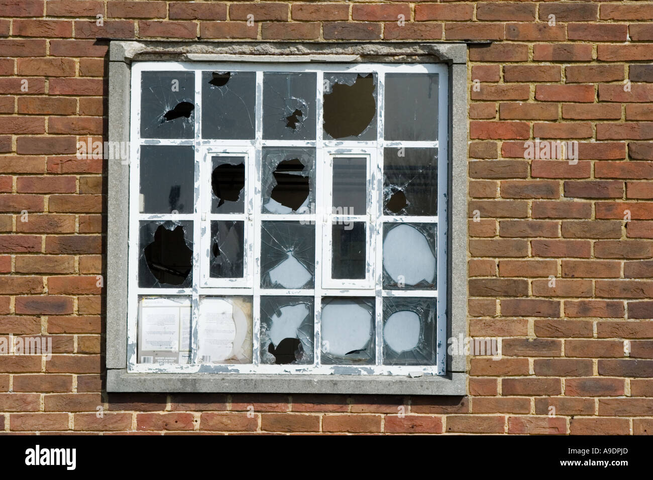 Broken windows in an empty and derelict office block Stock Photo - Alamy