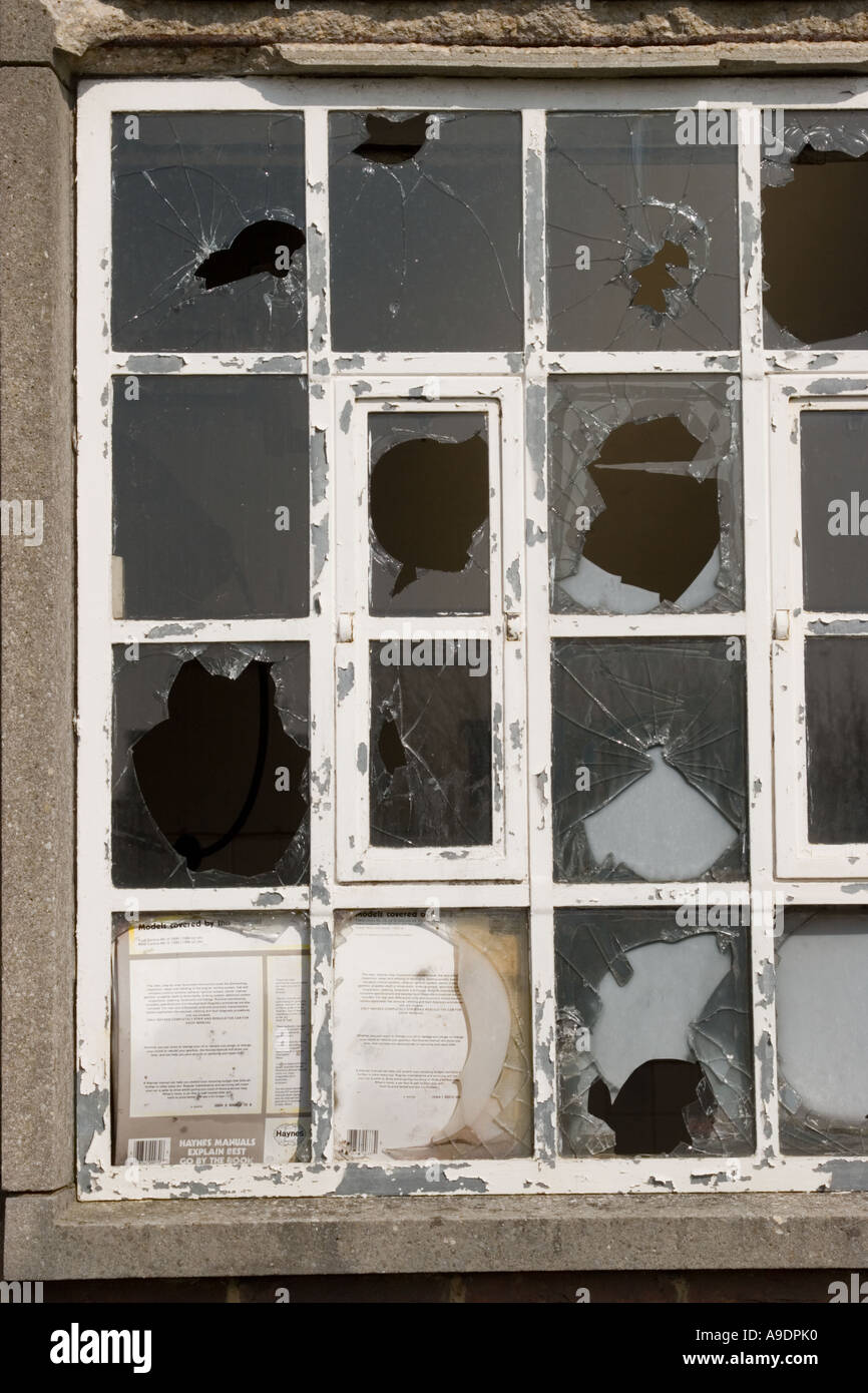 Broken windows in an empty and derelict office block, building on a ...