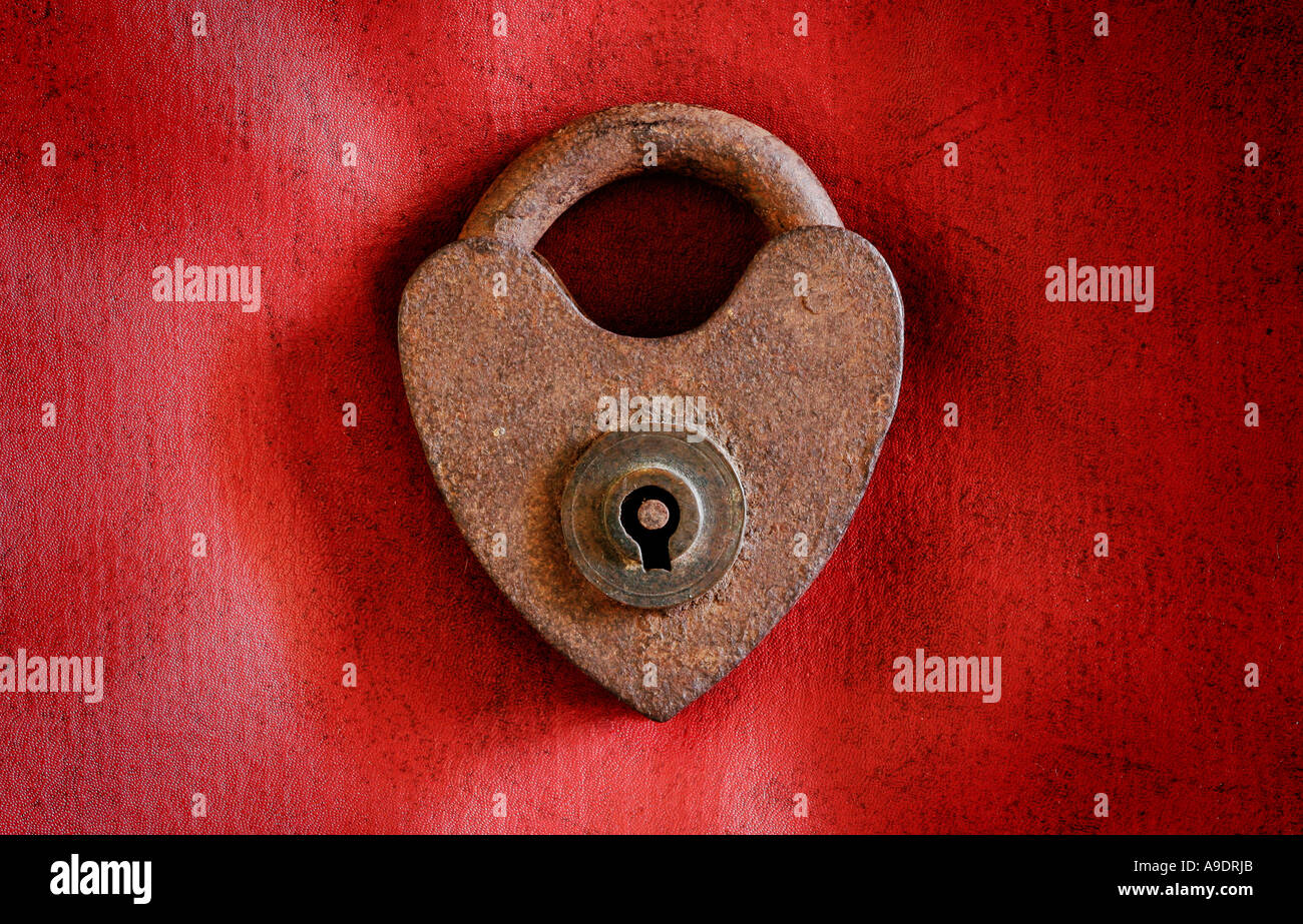 rusty heart shaped lock on bright red background Stock Photo - Alamy