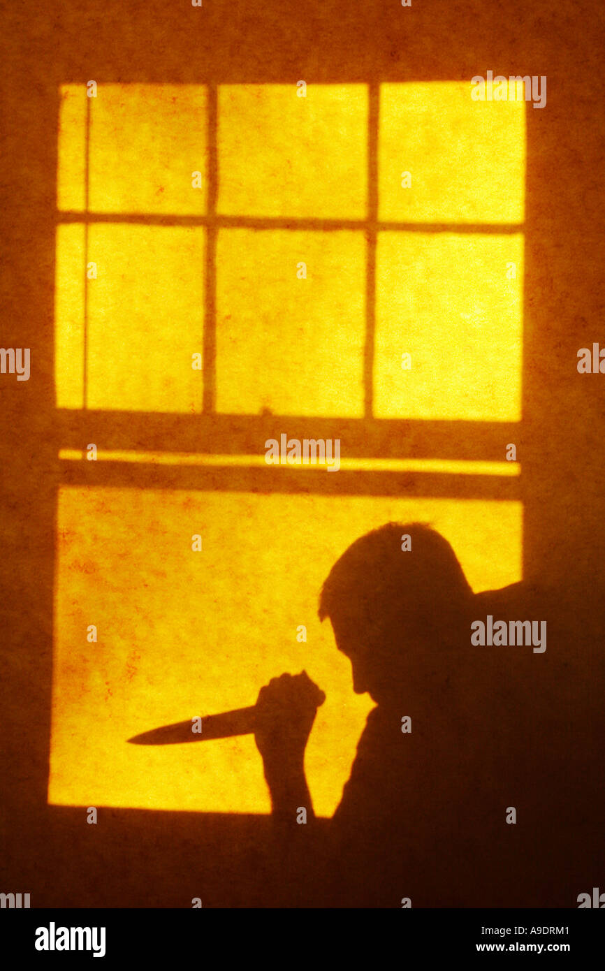silhouette of man with knife in window Stock Photo - Alamy