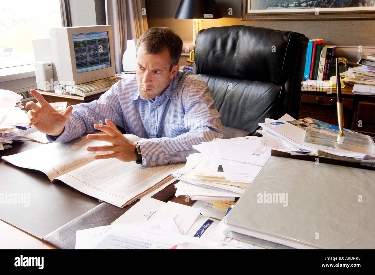 executive engaged in conversation at his desk Stock Photo - Alamy