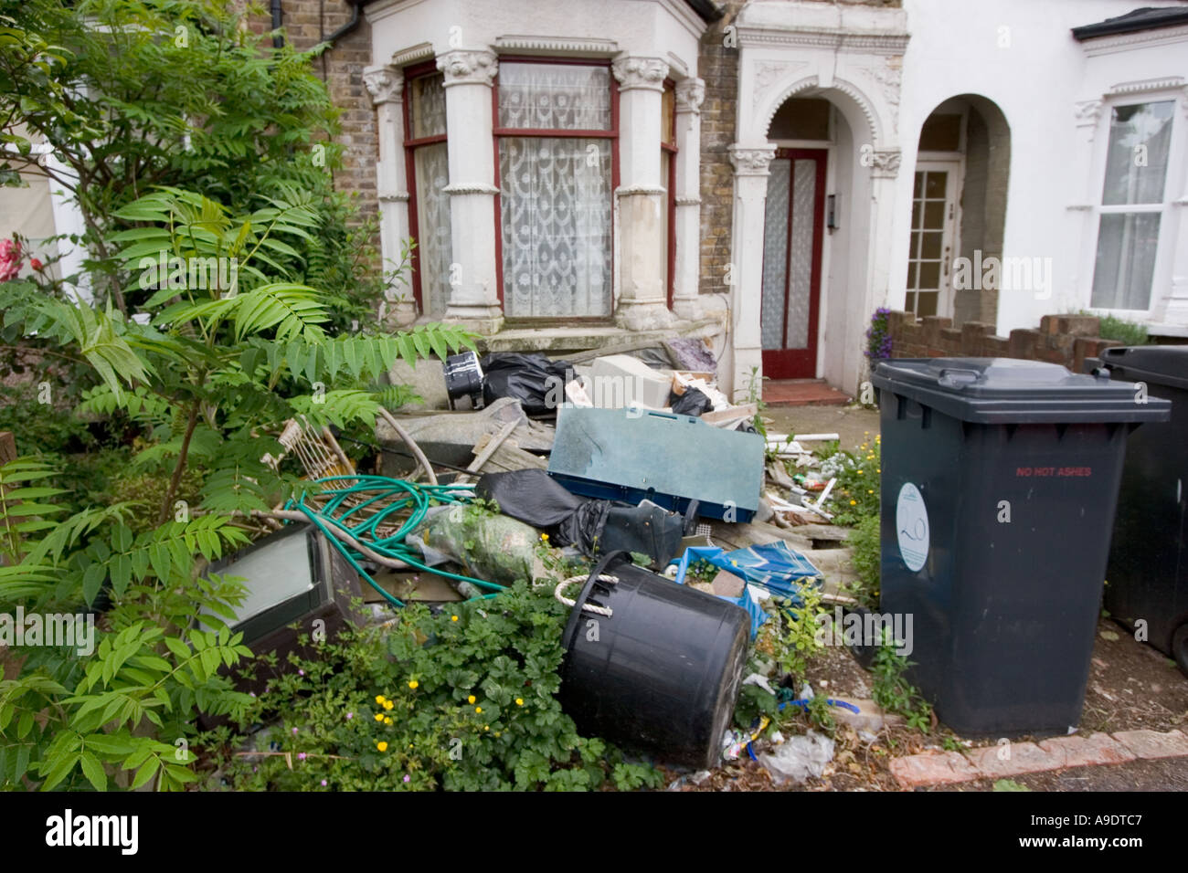 Front garden full of rubbish outside private residential housing ...
