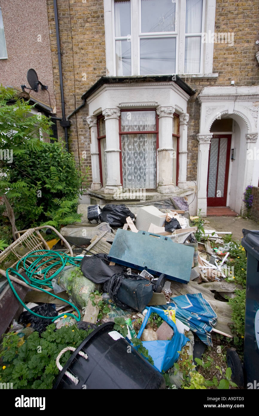 Front garden full of rubbish outside private residential housing ...
