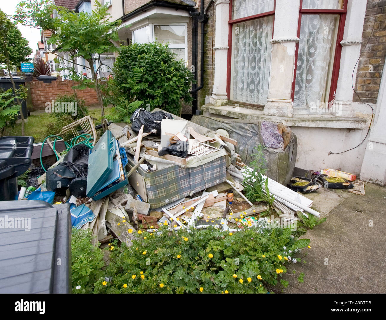 Front garden full of rubbish outside private residential housing ...