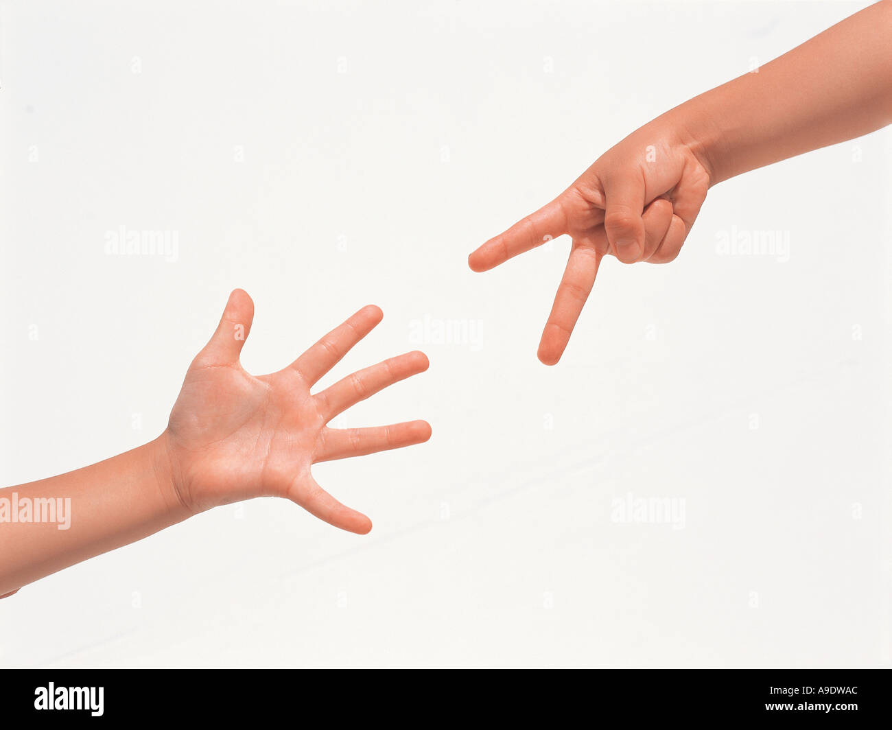 Kids playing rock paper scissors hi-res stock photography and images - Alamy