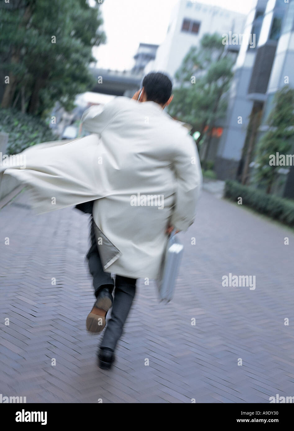 Business man running cell phone hi-res stock photography and images - Alamy