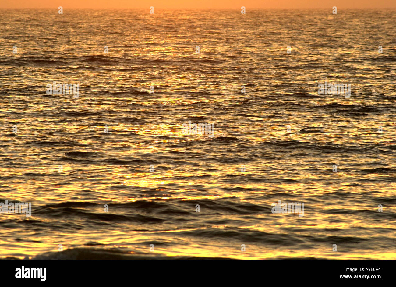Horizontal color image of ocean at sunset Stock Photo - Alamy
