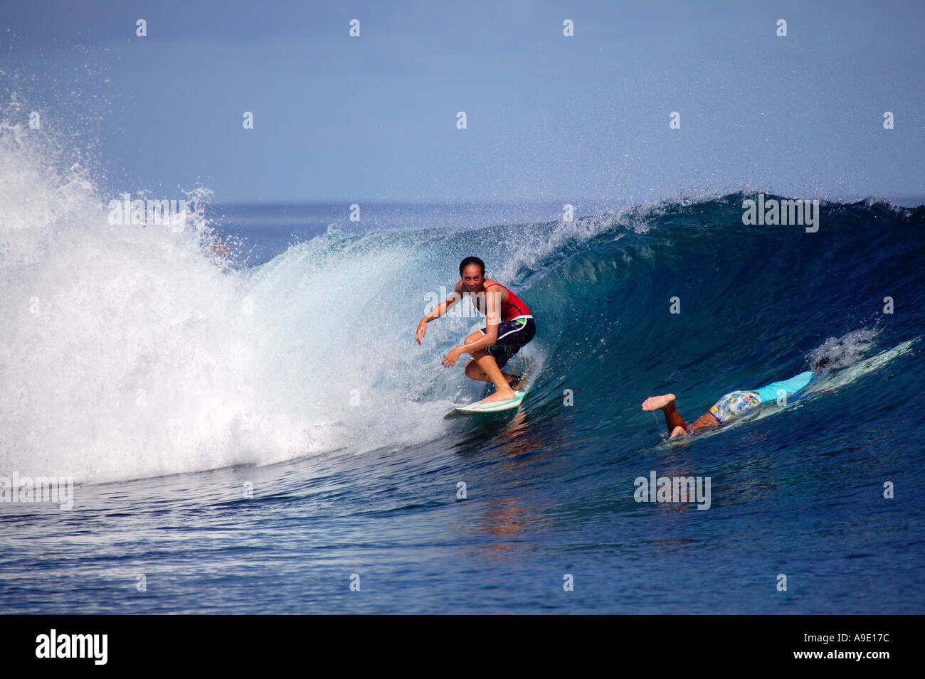 Girls surfing at cloudbreak Tavarua Fiji Model releases 395 396 Stock ...