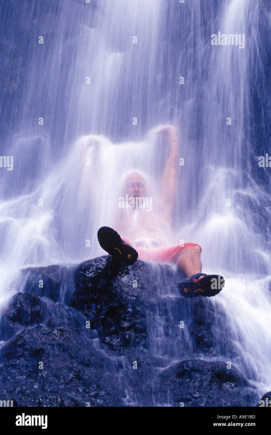 Man under waterfall hi-res stock photography and images - Alamy