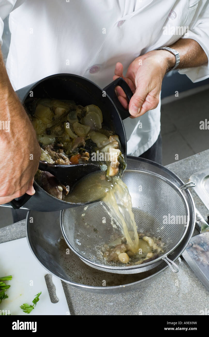 chef straining stock Stock Photo - Alamy