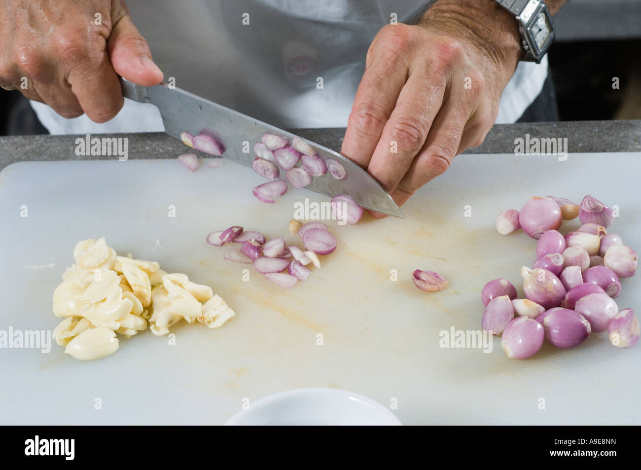 chef slicing onion and garlic Stock Photo - Alamy