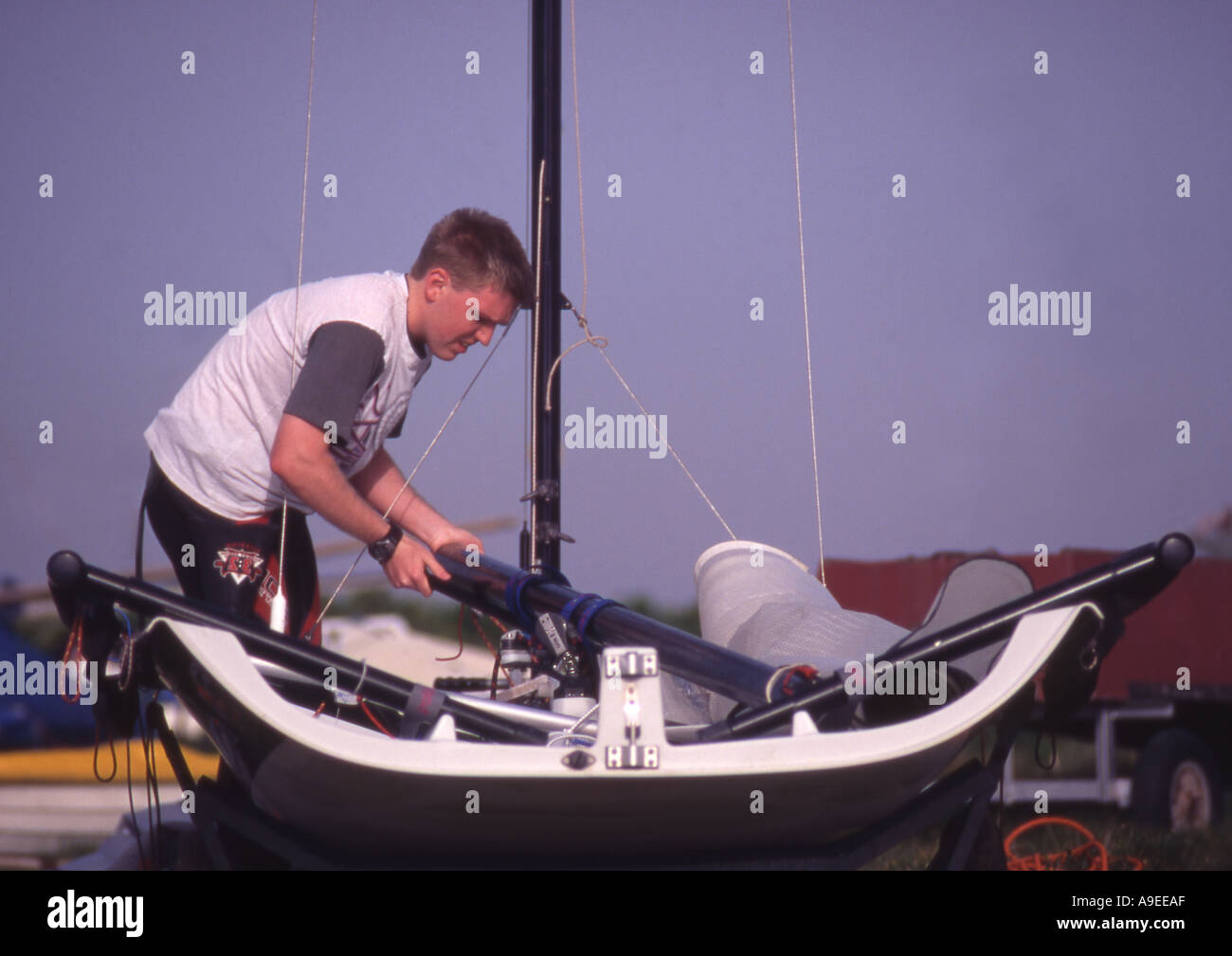 Young man setting up sailing dinghy at Blakeney Norfolk UK Stock Photo ...